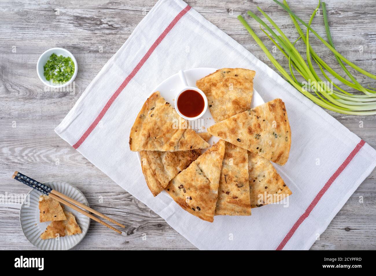 Taiwanese food - delicious flaky scallion pie pancakes on bright wooden ...