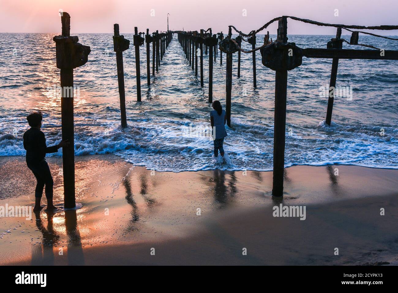 ALAPPUZHA, INDIA Tourist visiting the beach with the Christian cross to ...