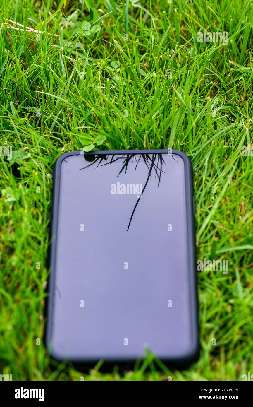 A smart phone on the ground. take break from the world Stock Photo - Alamy