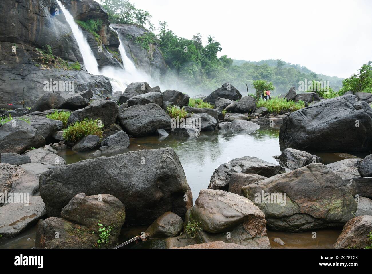 Misty forest and rocks, soothing Athirapally Vazhachal waterfall in ...