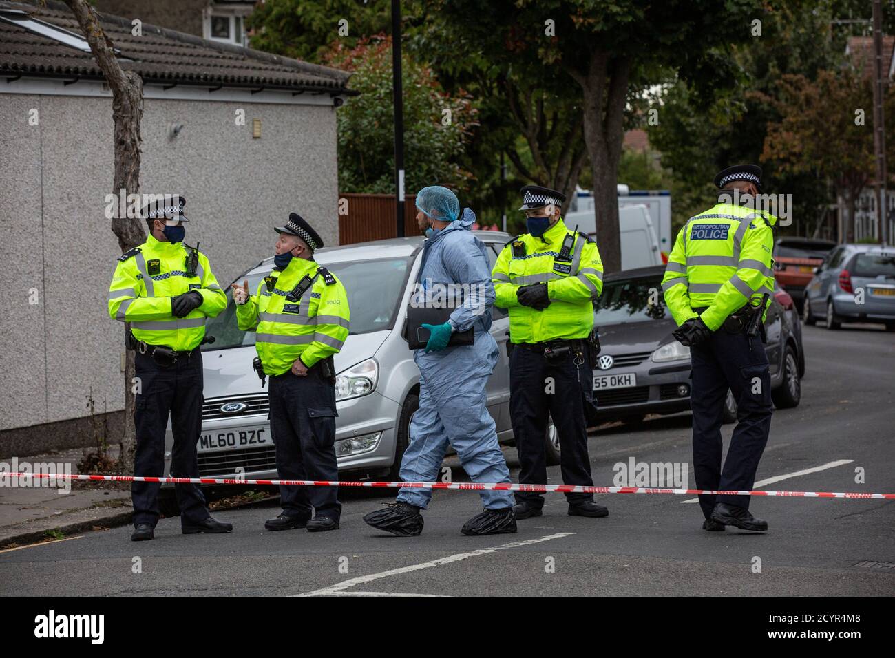 Metropolitan Police officers and Forensic officers outside the address ...
