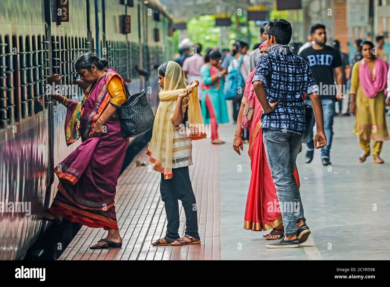 Lady in traditional saree boards train at railway station of Khozikode ...