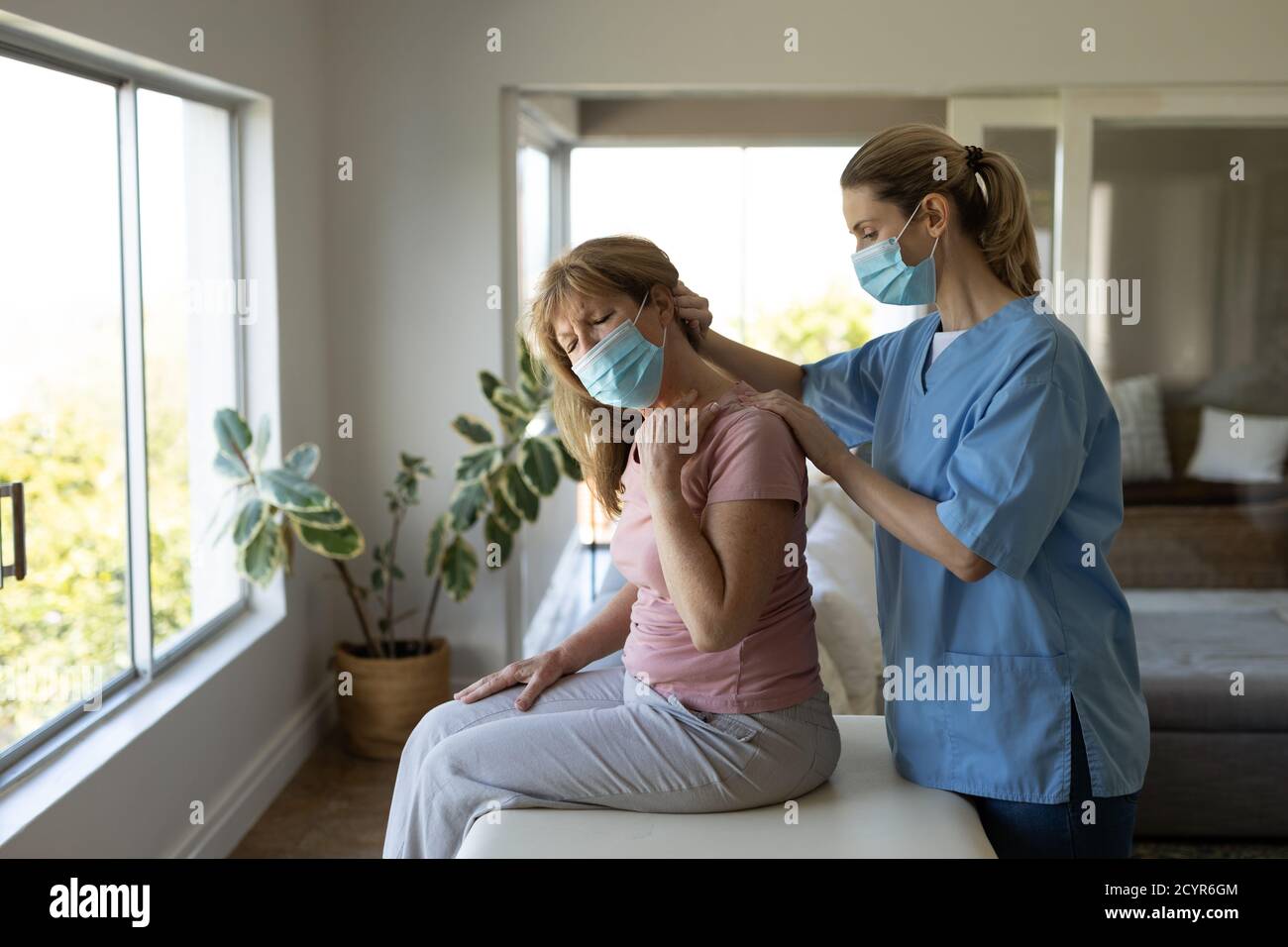 Senior Caucasian woman at home visited by Caucasian female nurse ...
