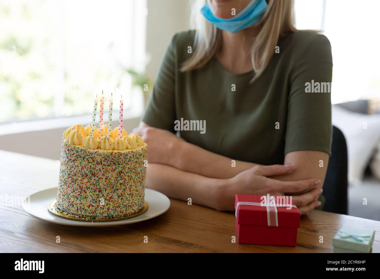 Caucasian woman spending time at home, sitting in living room with ...
