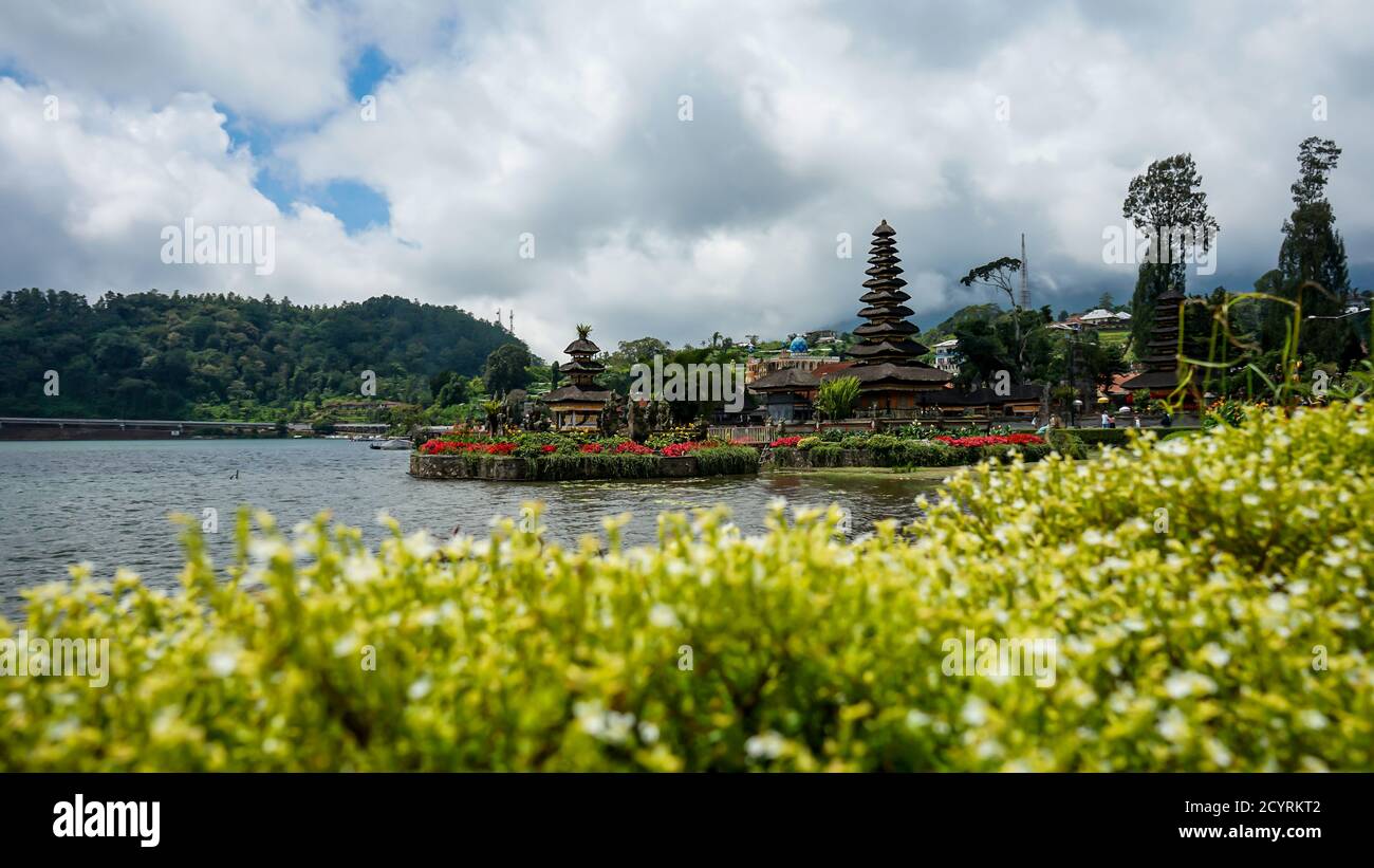 View of a Hindu temple building on the edge of a lake in Bali ...