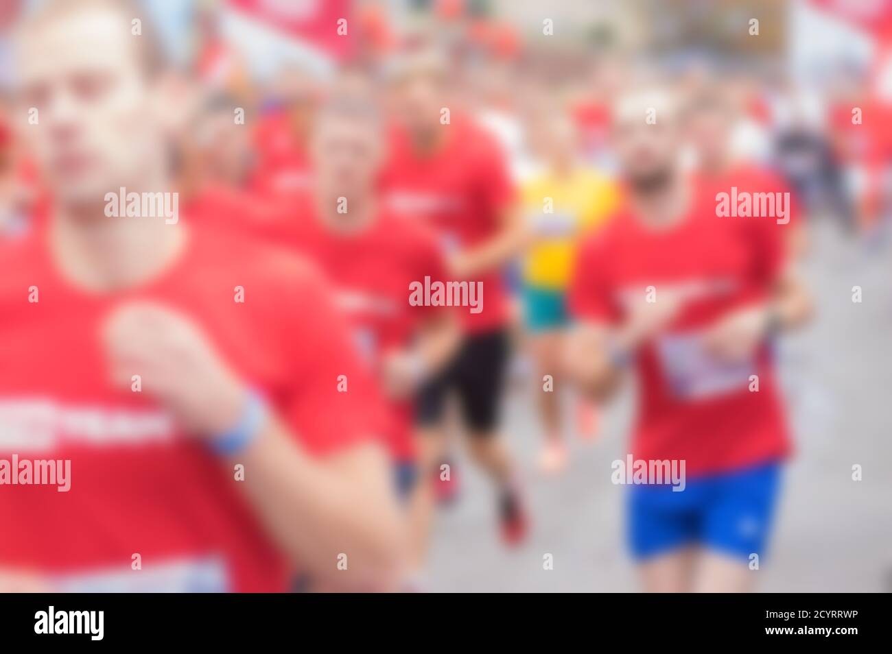 Blurry sport background - mass of people (mostly in red) running on a ...