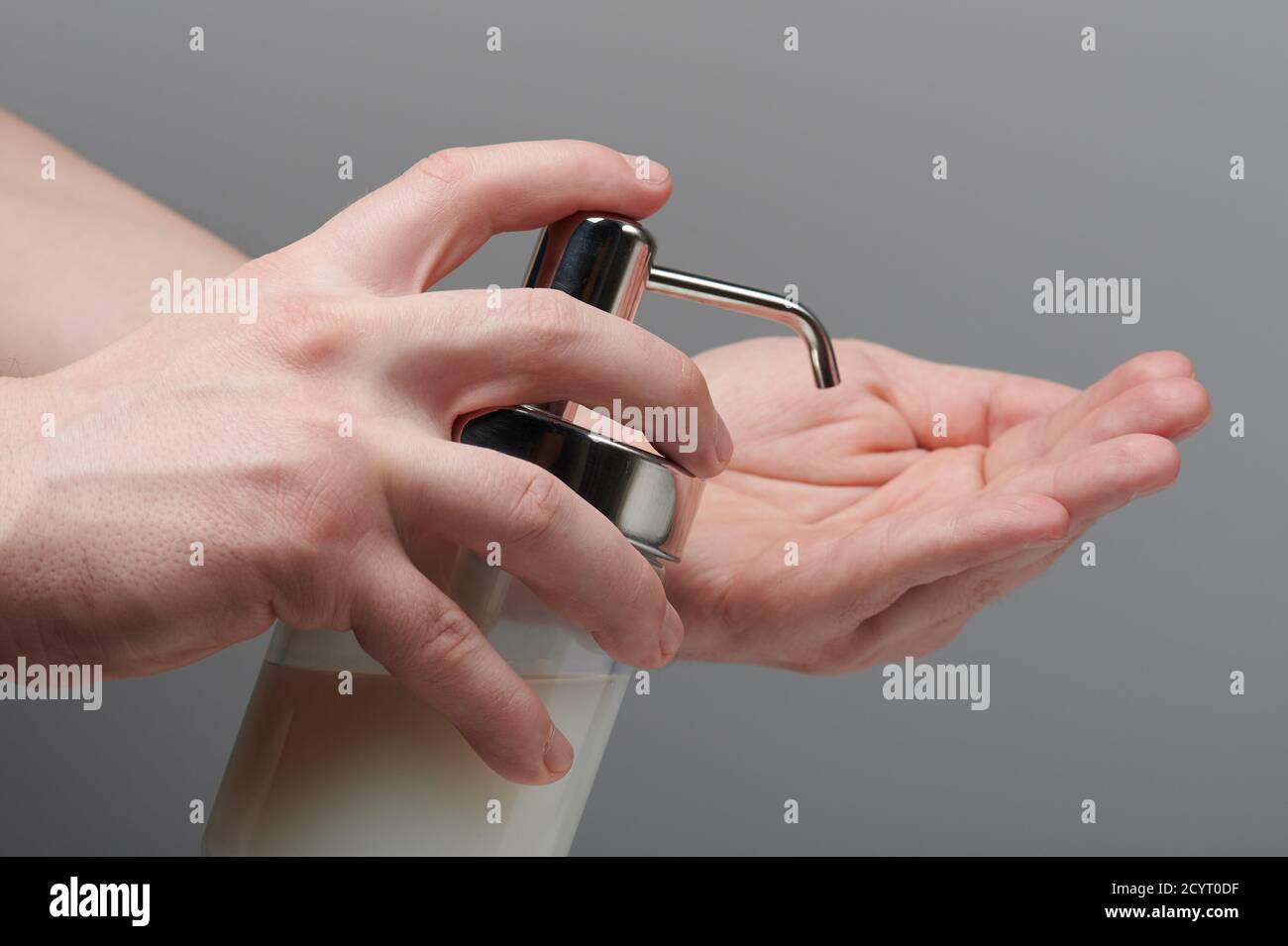 Sanitizing hands theme. Pouring soap on hands close up view Stock Photo ...
