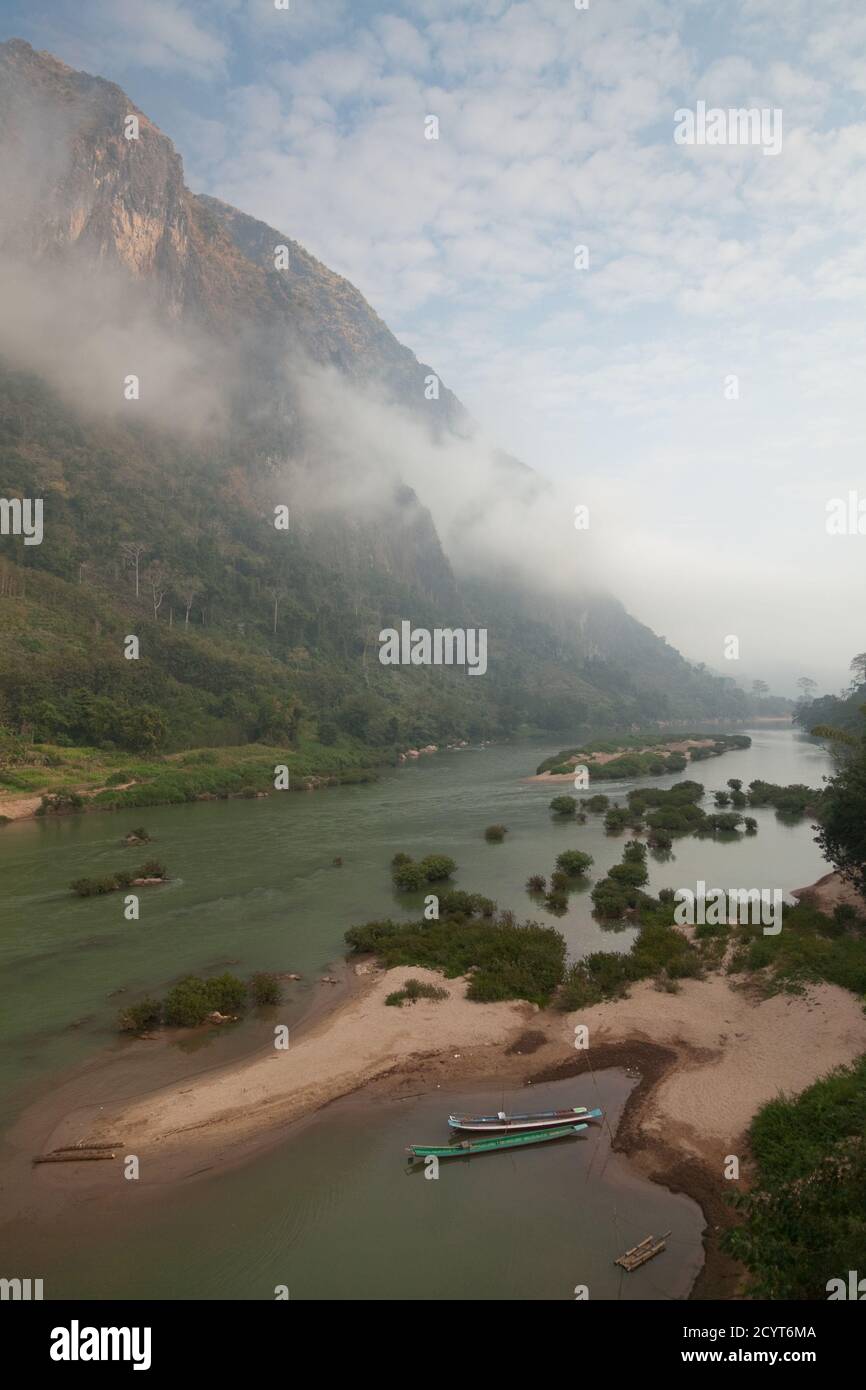 Nam Ou River, boats and landscape with mountains and riverside villages ...