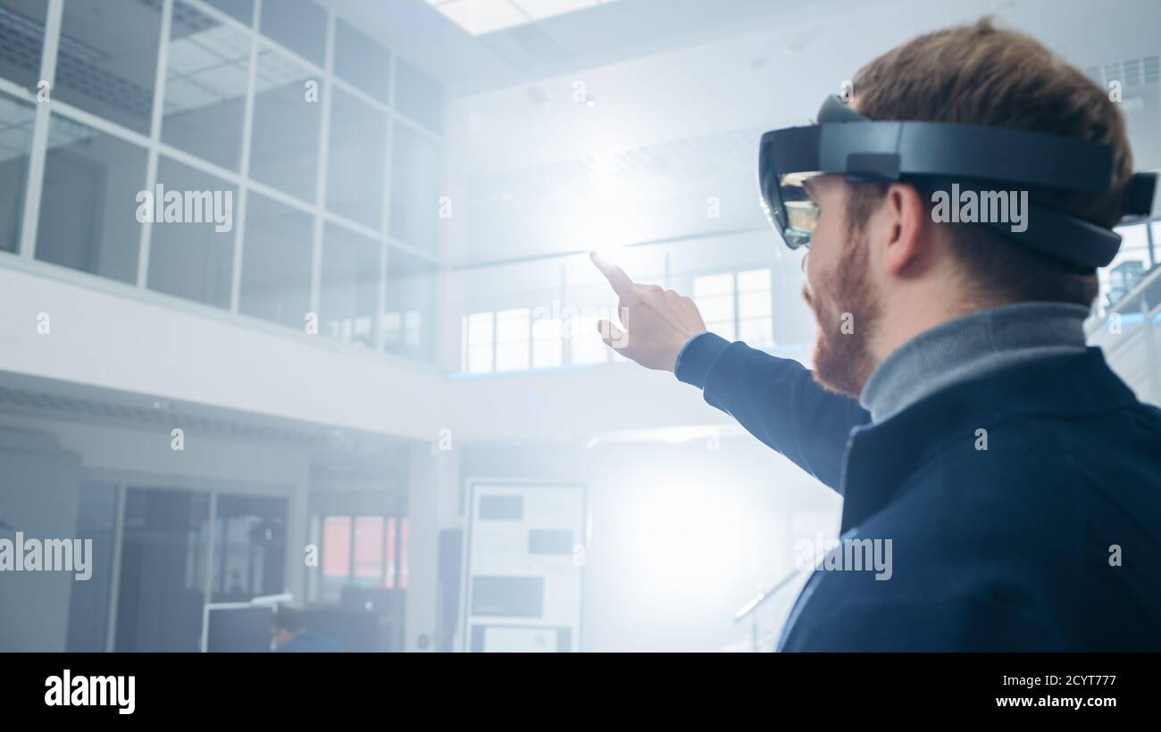 Automotive Engineer Using Augmented Reality Headset and Making Touching Gestures of Virtual ...