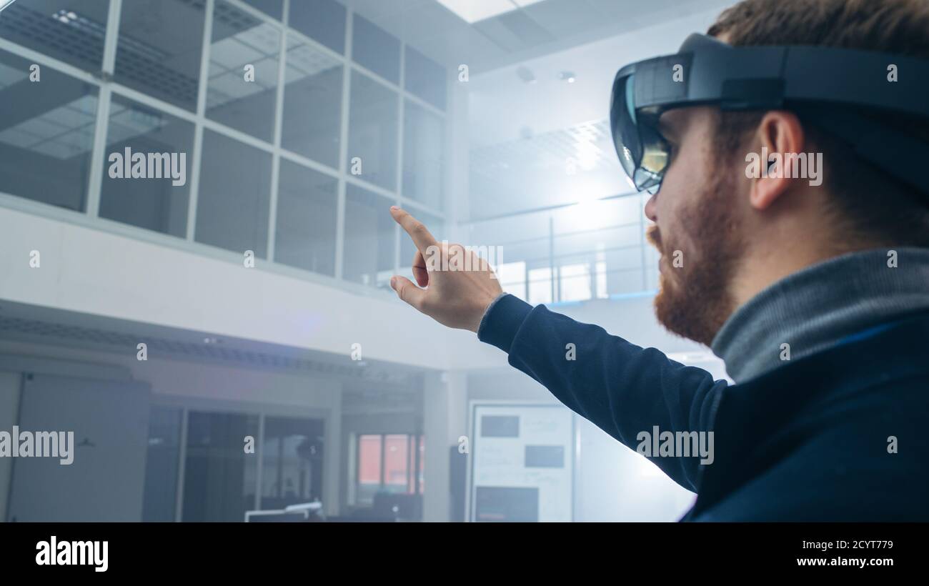 Automotive Engineer Using Augmented Reality Headset and Making Touching Gestures of Virtual ...