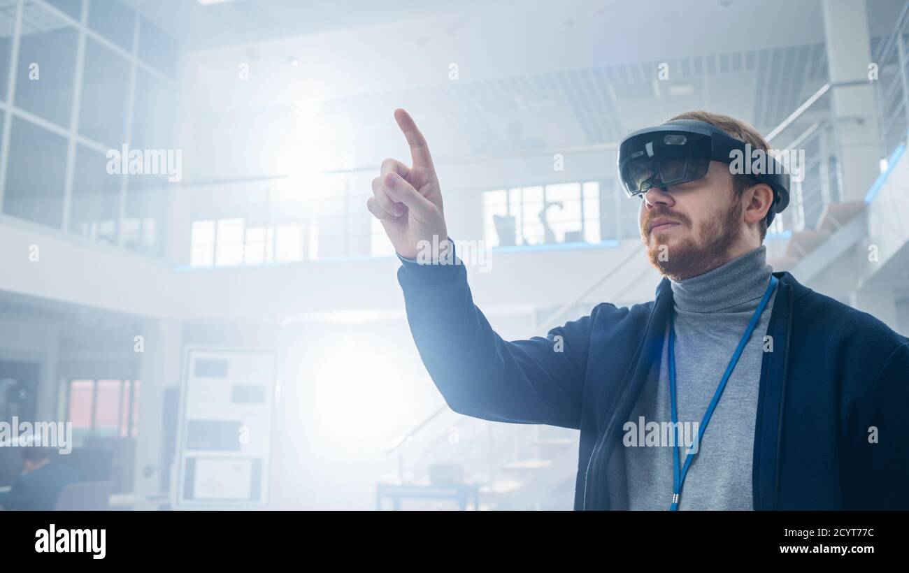 Automotive Engineer Using Augmented Reality Headset and Making Touching Gestures of Virtual ...