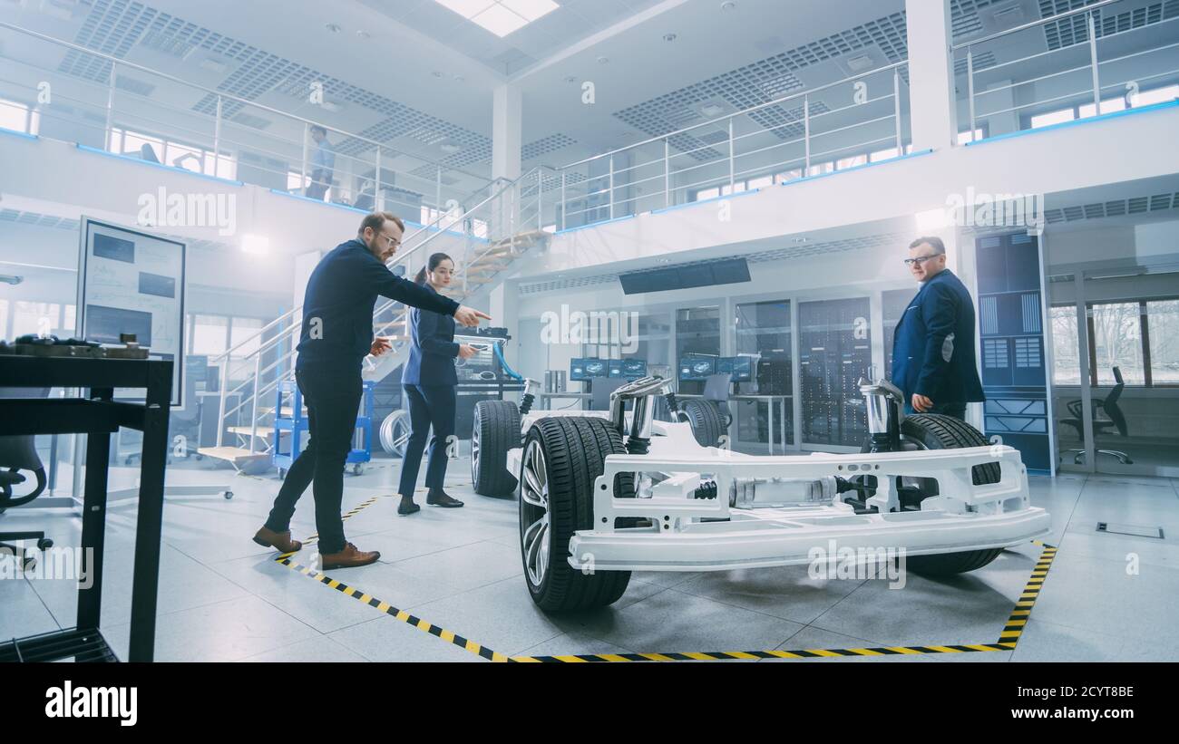 Automotive Design Engineers Talking while Working on Electric Car ...