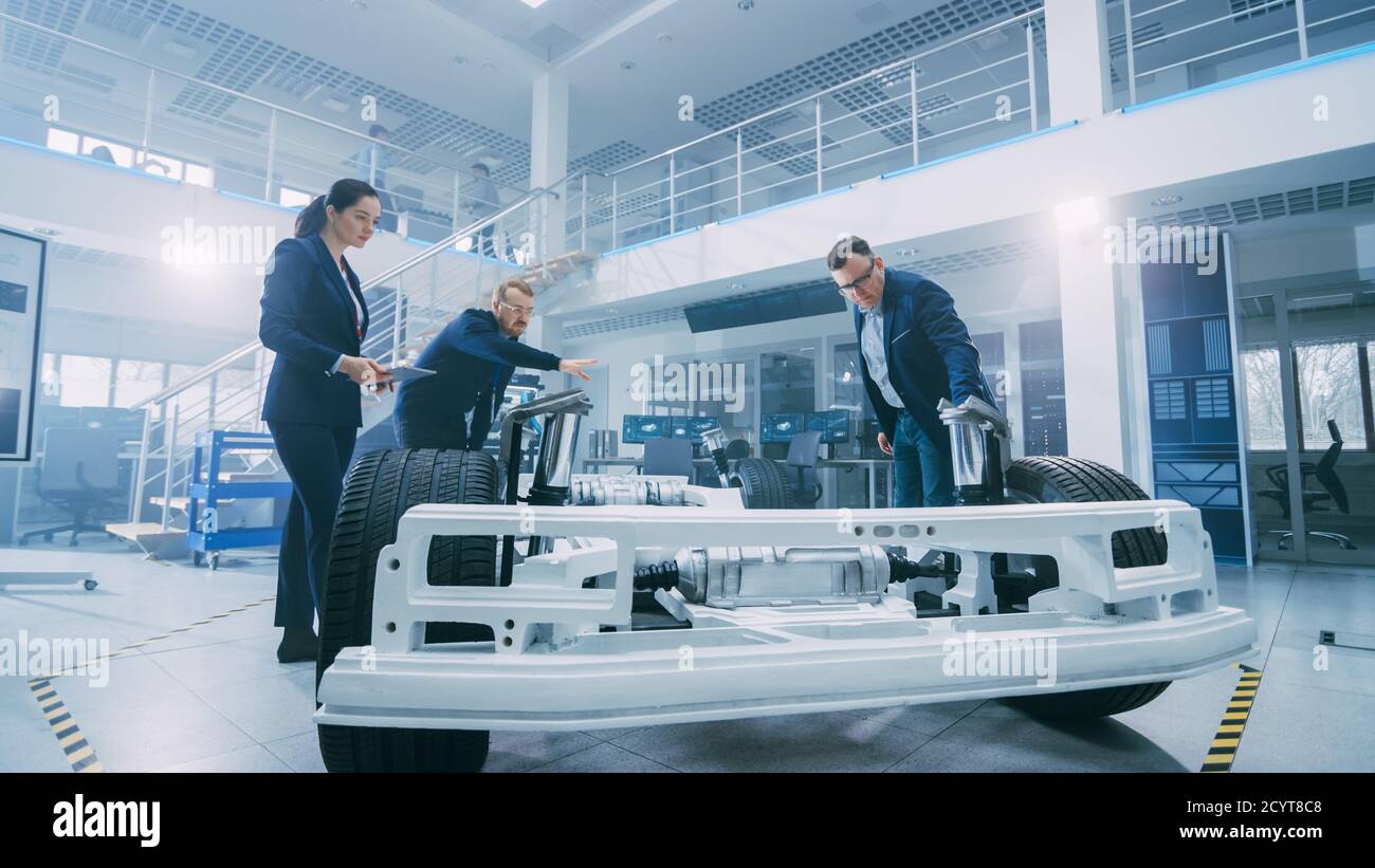 Automotive Design Engineers Talking while Working on Electric Car ...