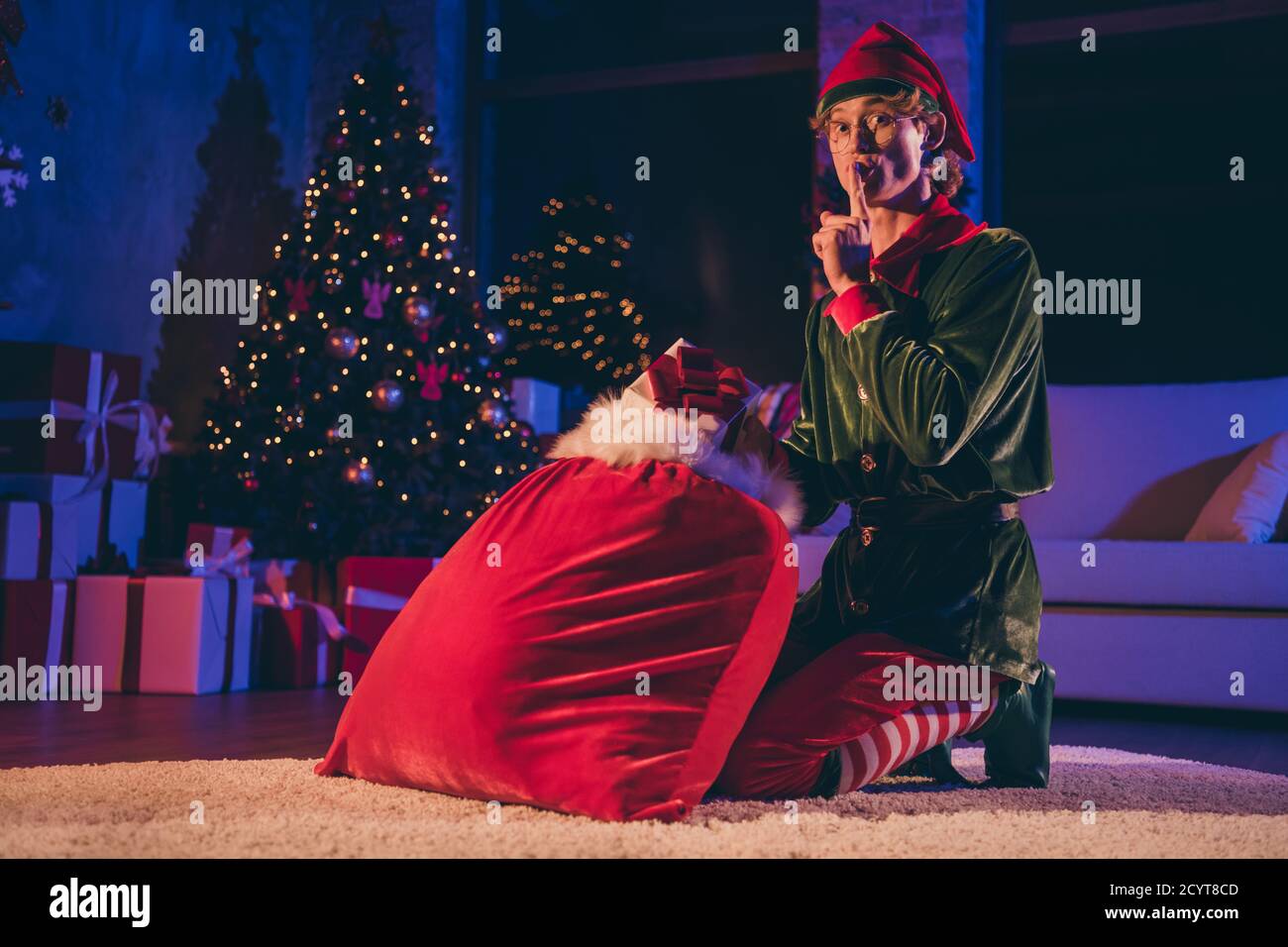 Full body photo of elf sit floor with big sack x-mas christmas delivery ...