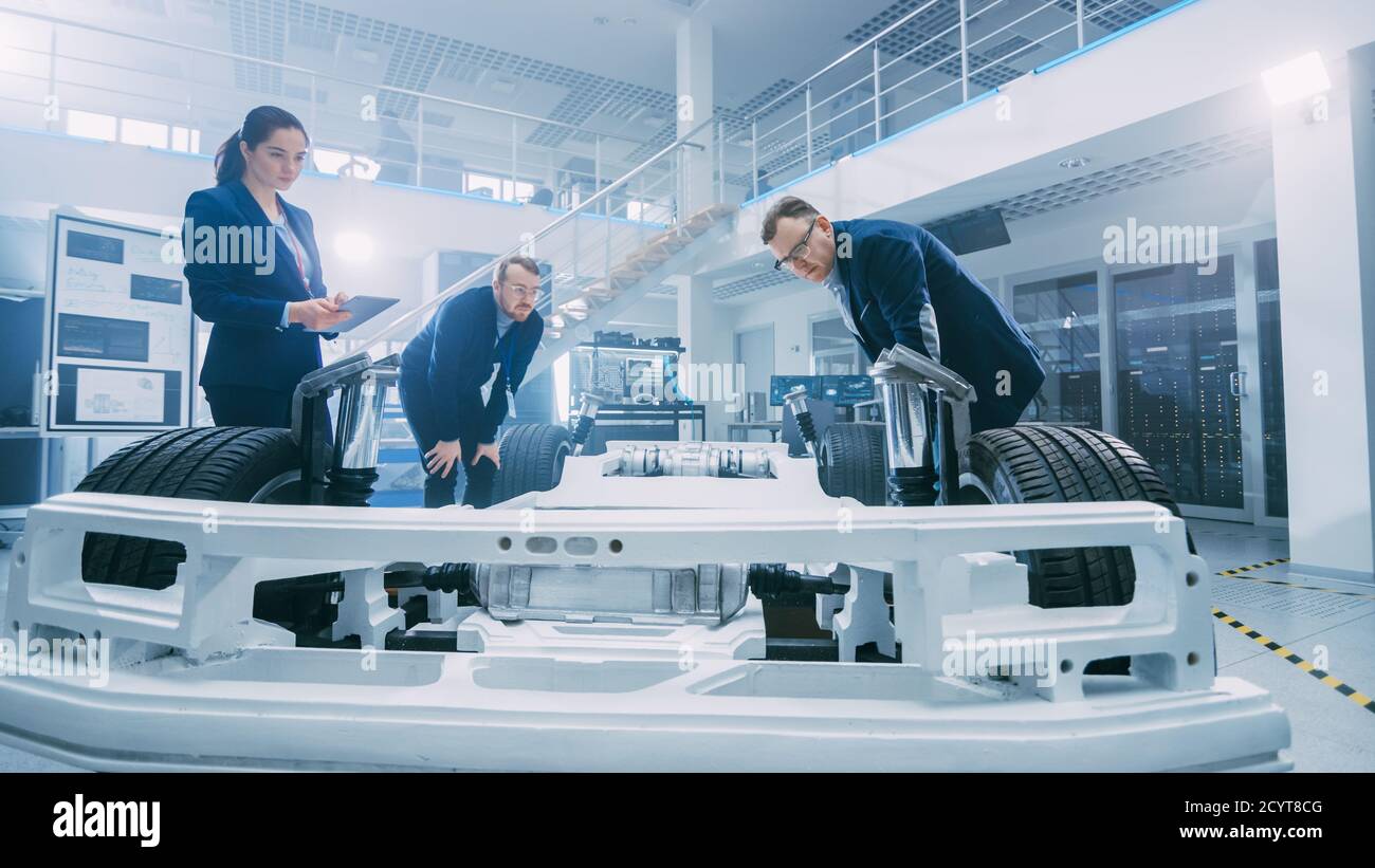 Automotive Design Engineers Talking while Working on Electric Car ...