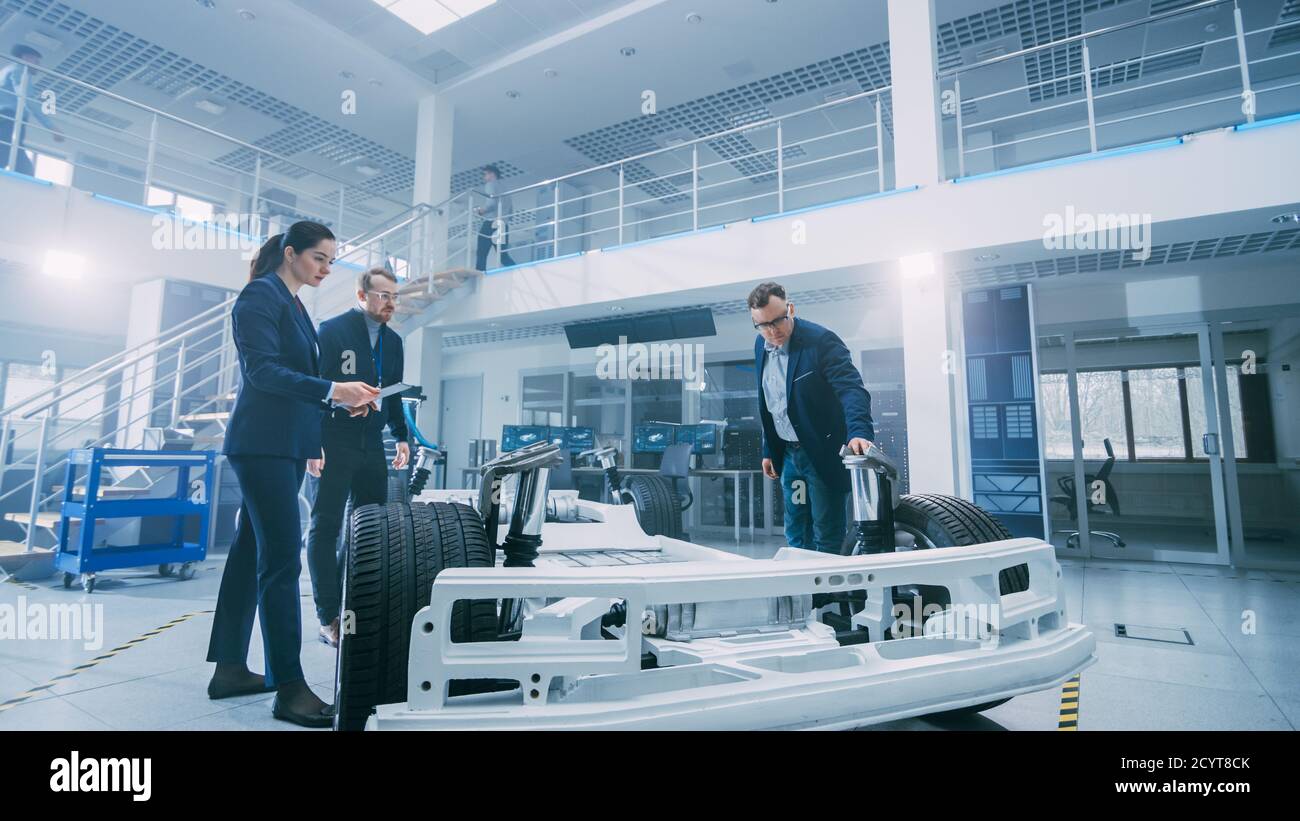 Automotive Design Engineers Talking while Working on Electric Car ...