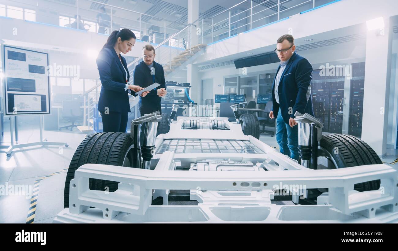 Automotive Design Engineers Talking while Working on Electric Car ...