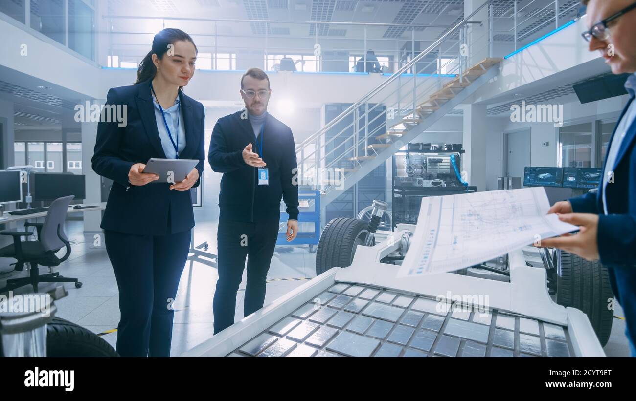 Automotive Design Engineers Talking while Working on Electric Car ...