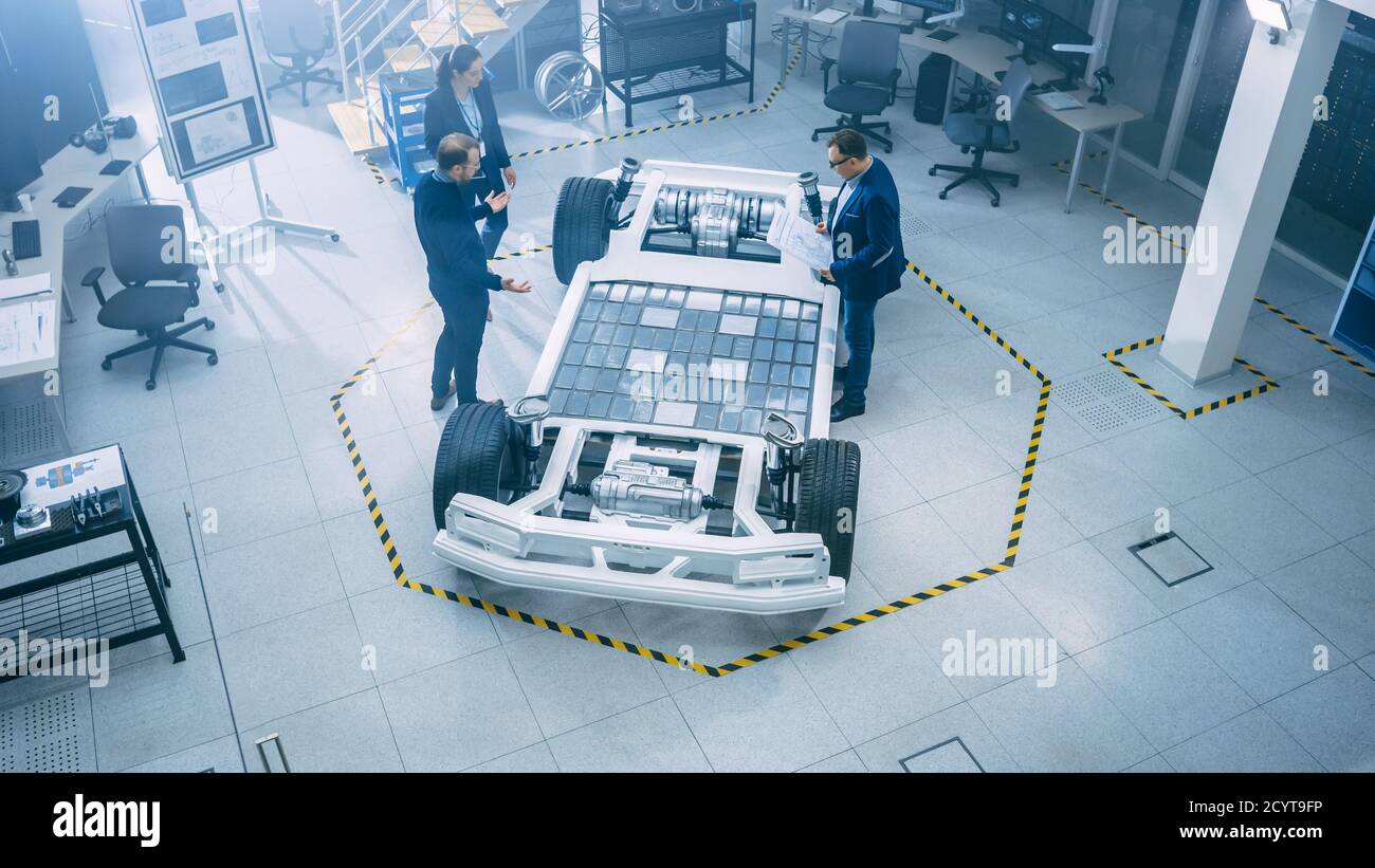 Automotive Design Engineers Talking while Working on Electric Car ...