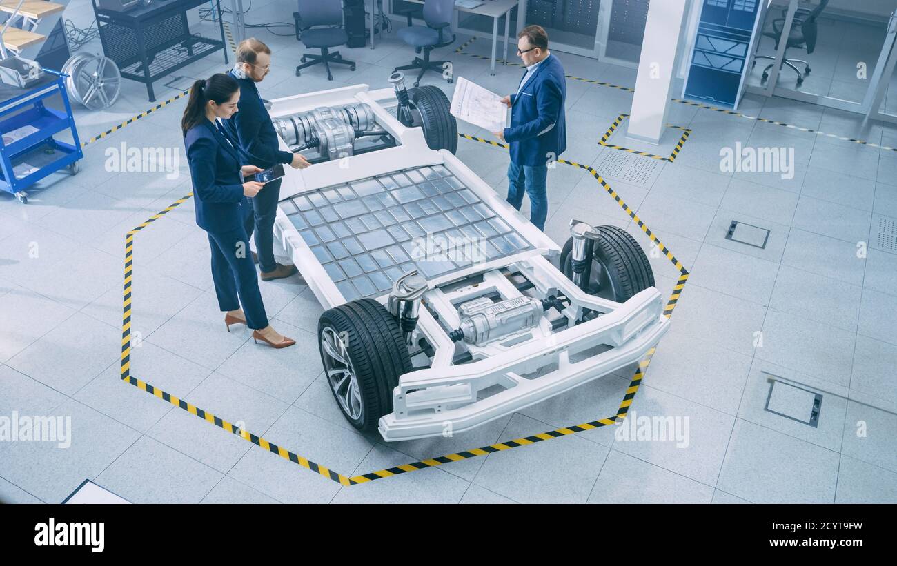 Automotive Design Engineers Talking while Working on Electric Car ...