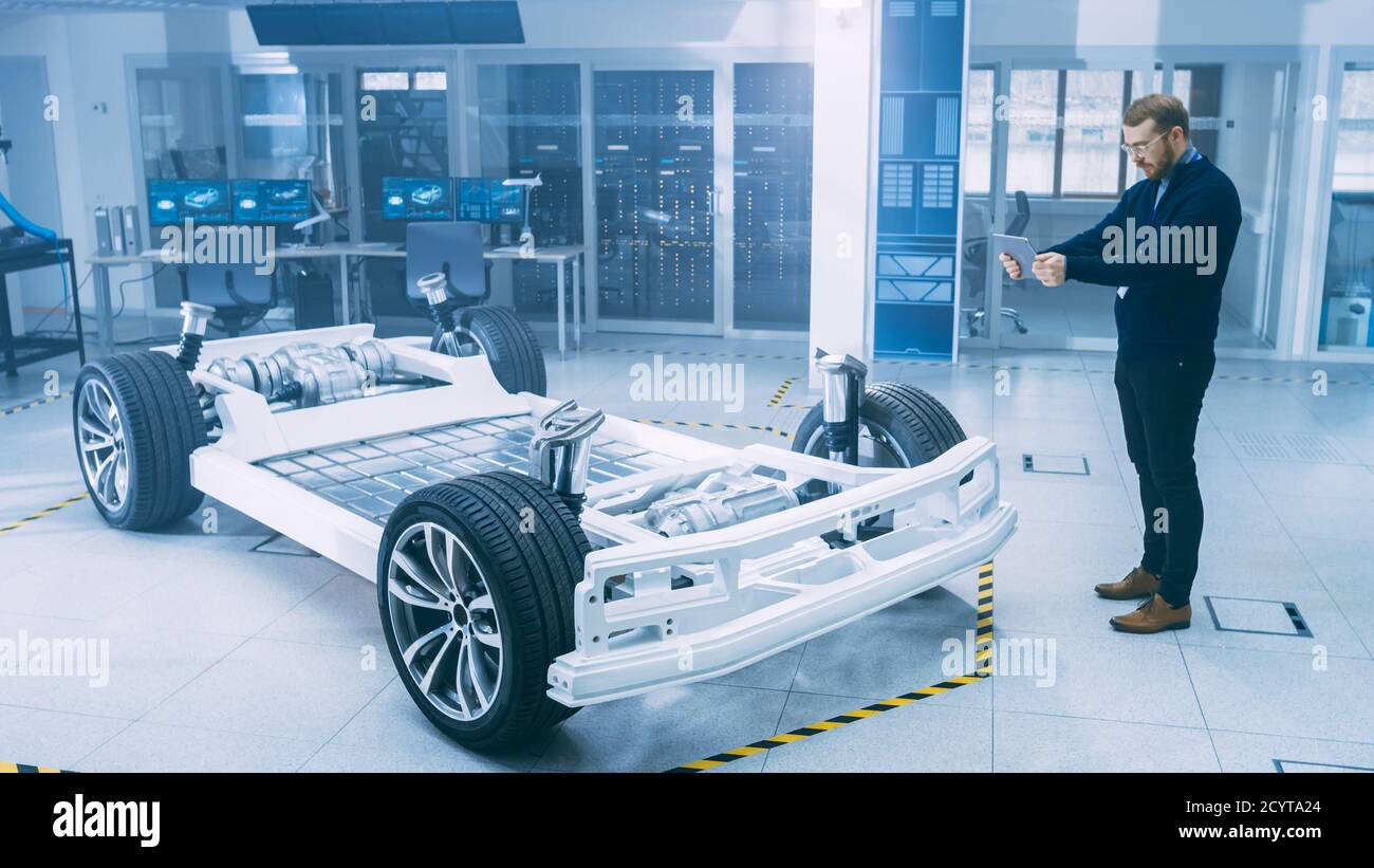 Engineer with Glasses and Beard Scans Electric Car Chassis Prototype ...