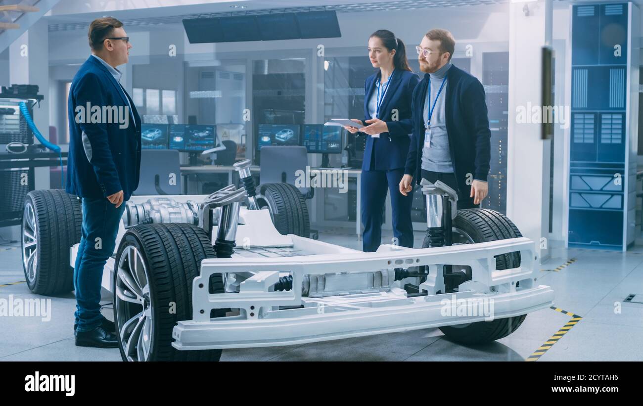Automotive Design Engineers Talking while Working on Electric Car ...