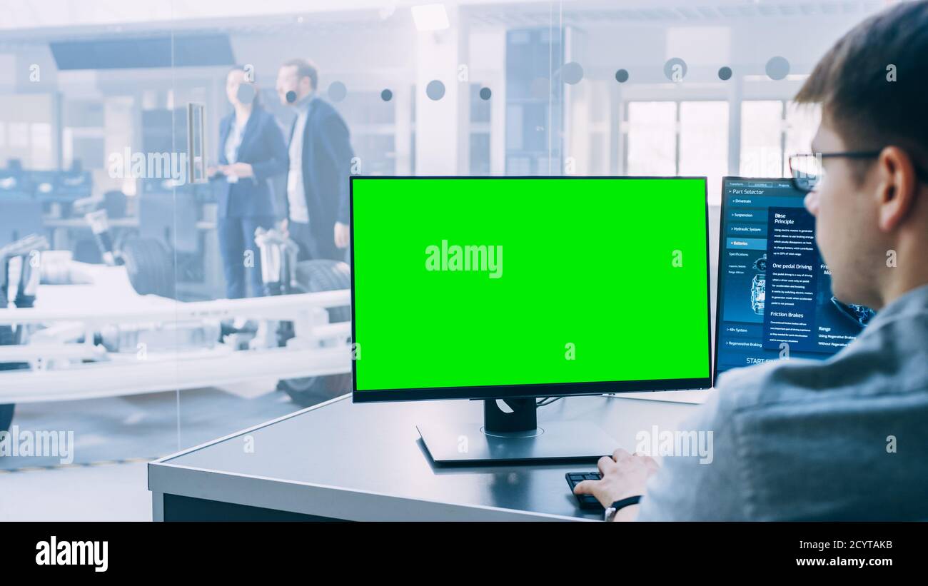 Professional Engineer Works on a Computer with Green Screen Mock-up ...
