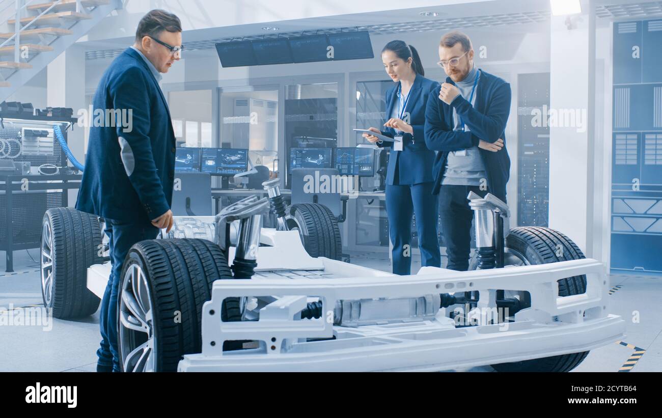 Automotive Design Engineers Talking while Working on Electric Car ...