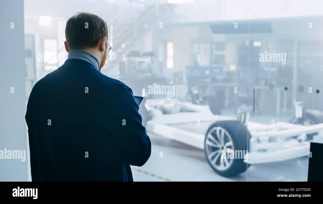 Male Engineer is Working in a High Tech Development Facility Holding a ...