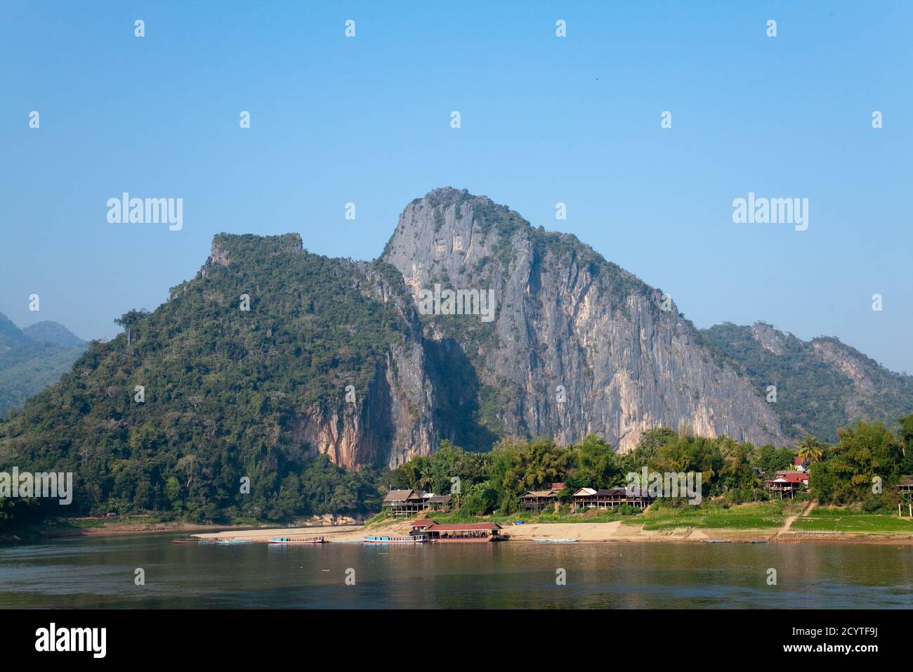 Nam Ou River, boats and landscape with mountains and riverside villages ...