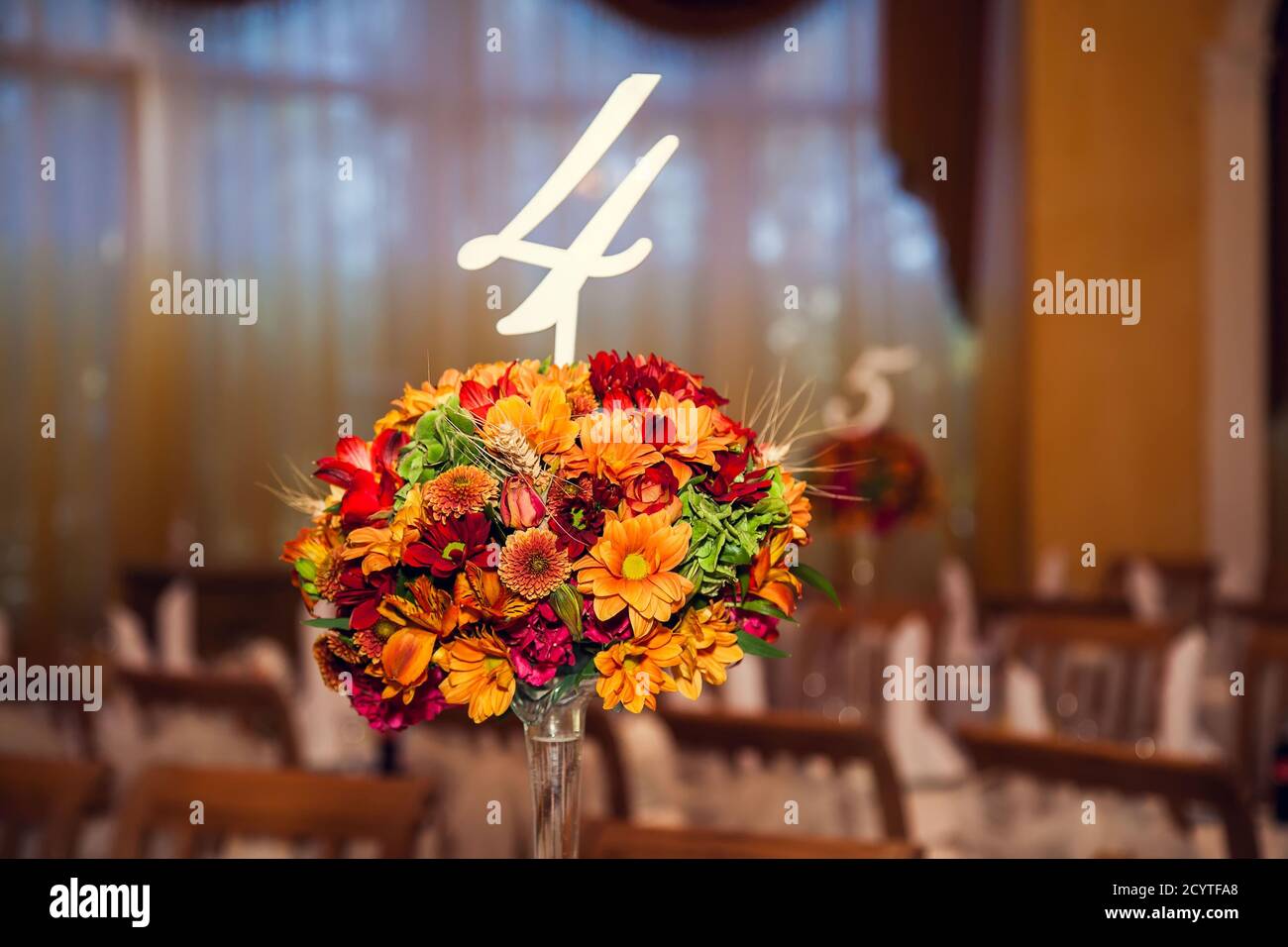 The hall in the restaurant, decorated with flowers in the autumn style ...