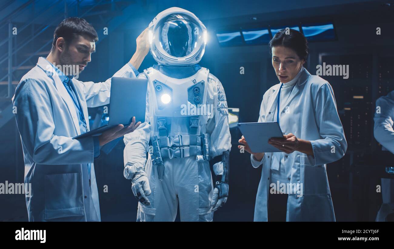 Diverse Team of Aerospace Scientists and Engineers Wearing White Coats ...