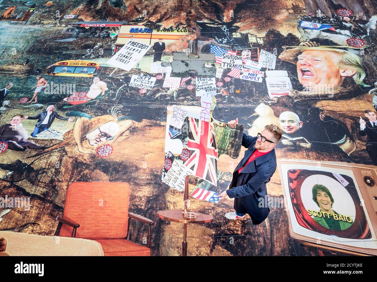 Artist Cold War Steve with the final piece of a jigsaw, of his art work ...