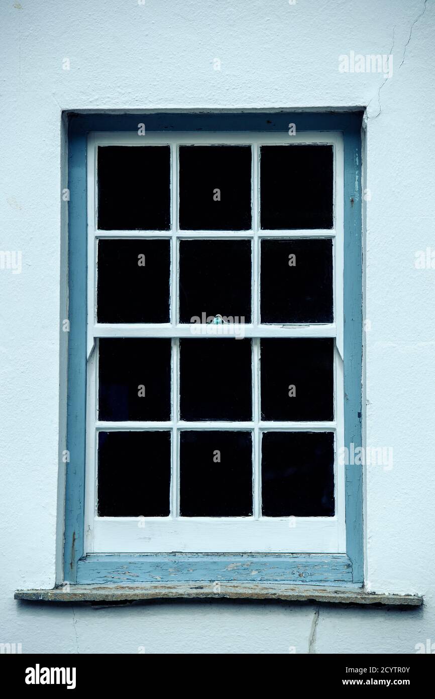Sash window with a blue painted frame on a cottage in the village of ...