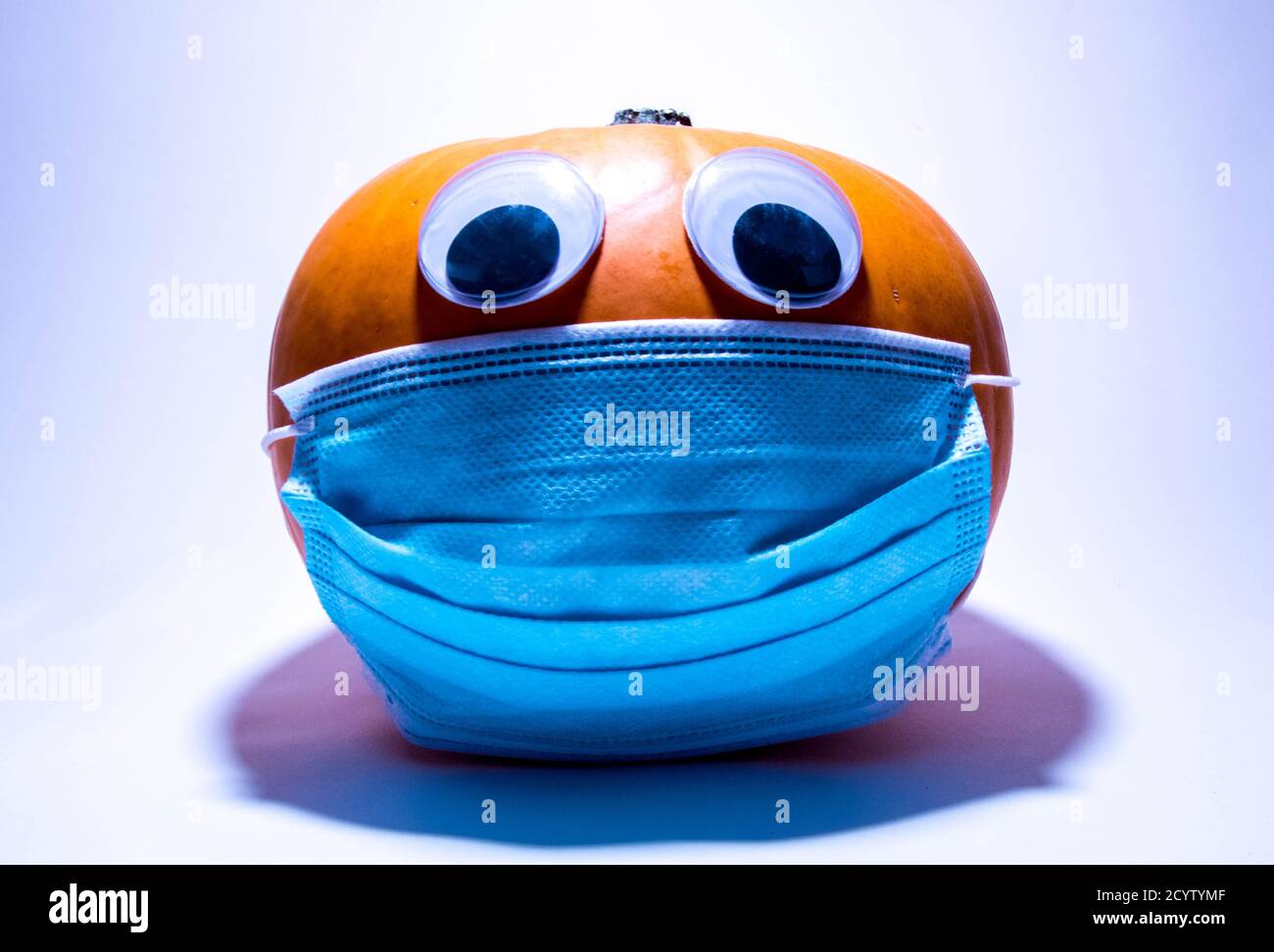 A Halloween pumpkin, with eyes, wearing a surgical mask during the ...