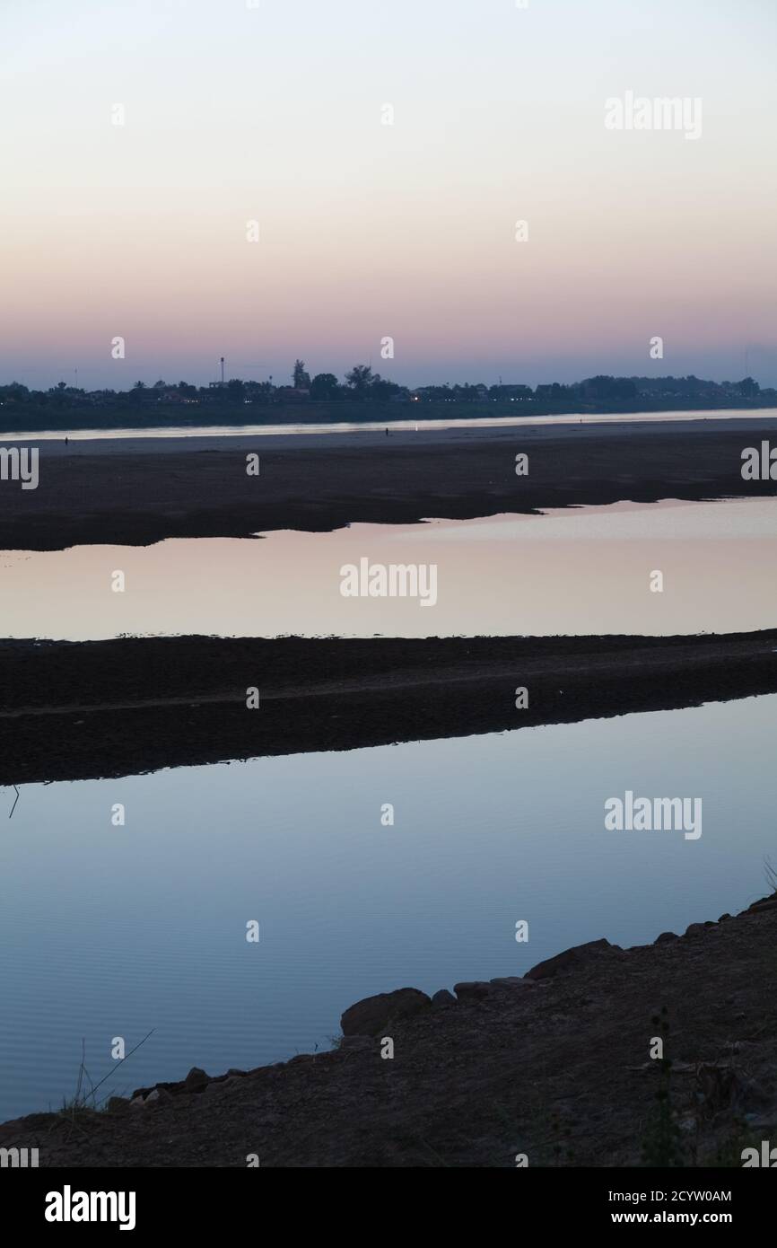 Mekong River, Vientiane, Laos at sunset, with silhouettes reflecting in ...