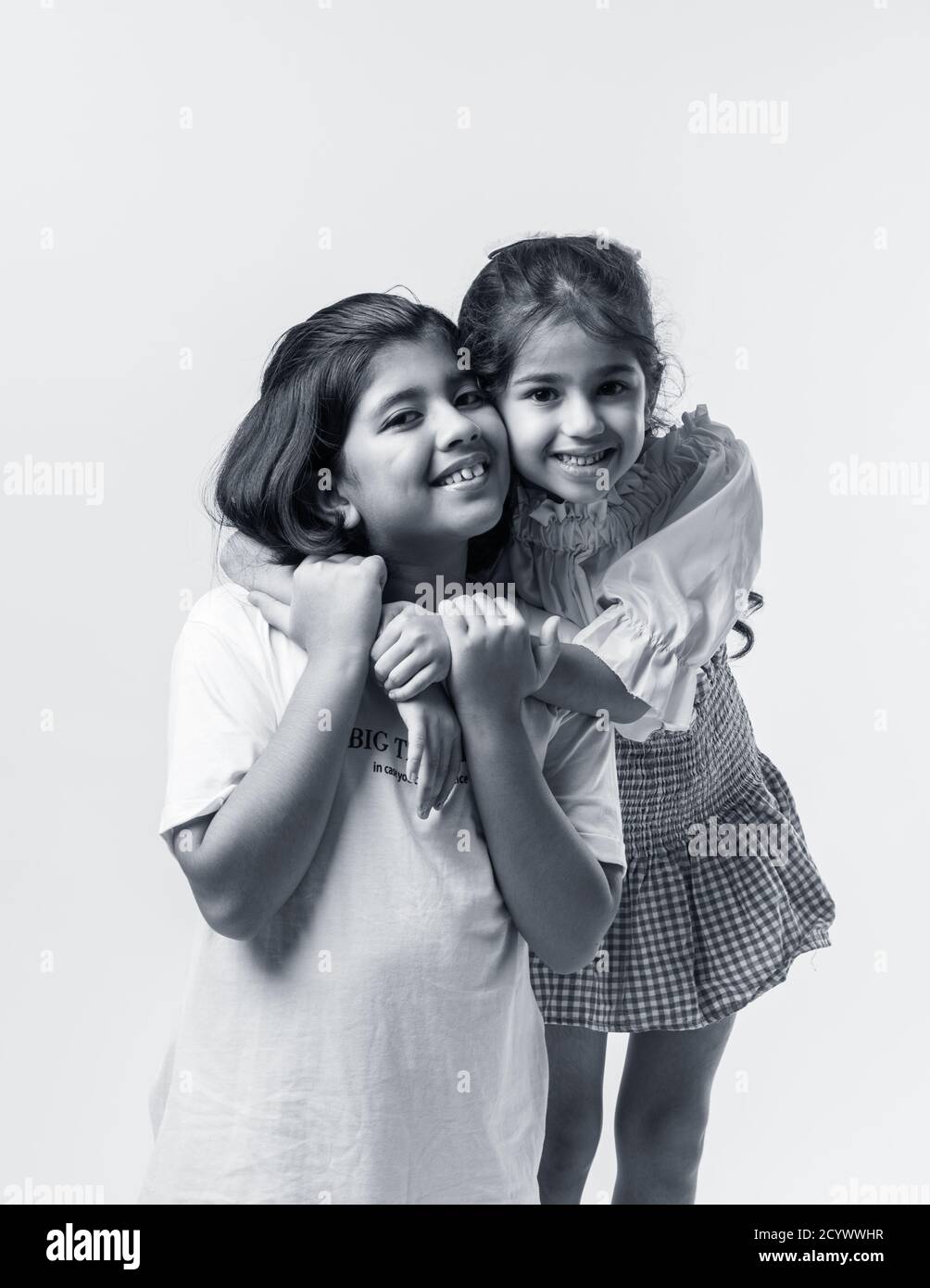 Cute little Indian asian siblings standing and embracing each other in ...