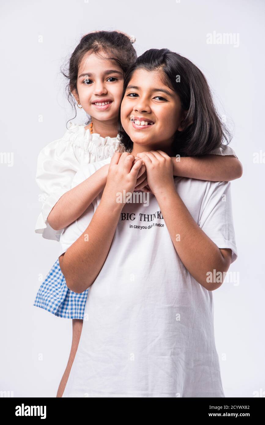 Cute little Indian asian siblings standing and embracing each other in ...