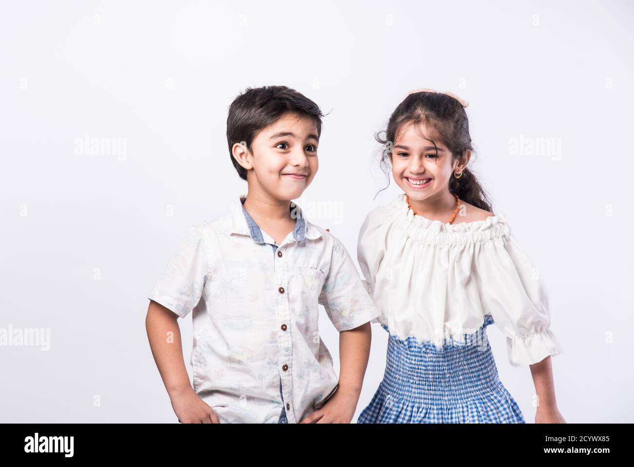 Cute little Indian asian siblings standing and embracing each other in ...