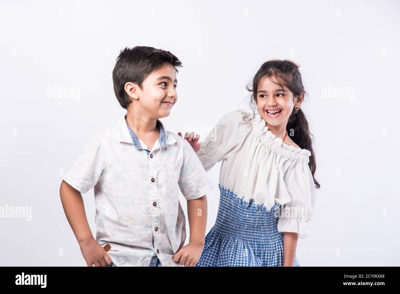 Cute little Indian asian siblings standing and embracing each other in ...