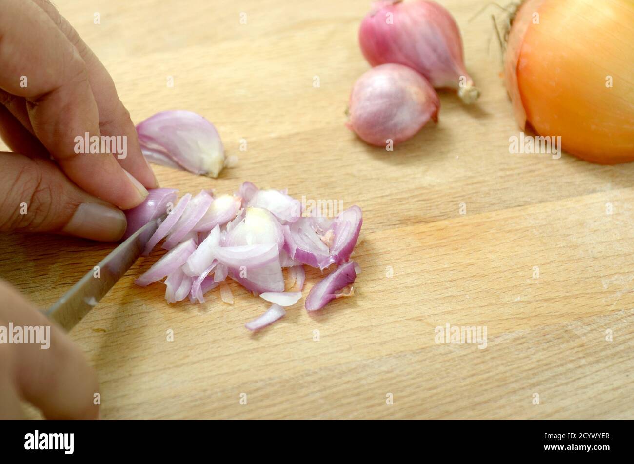 hand with knife, cutting and chopping red onion for cooking Stock Photo ...