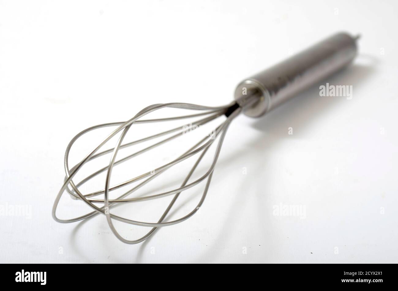 stainless steel whisk on a white background Stock Photo - Alamy