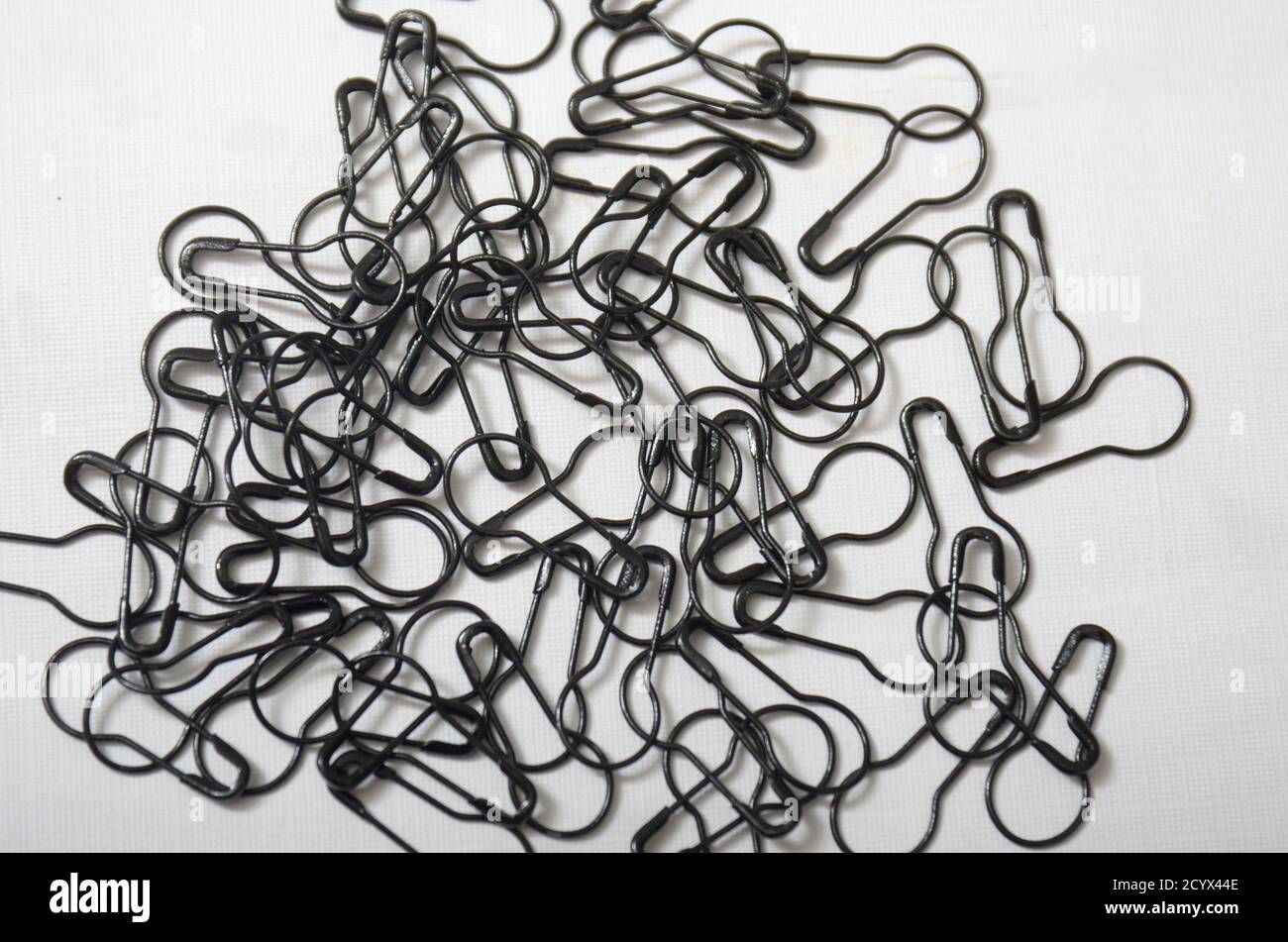group of Small Black Safety Pin Isolated on White Stock Photo - Alamy