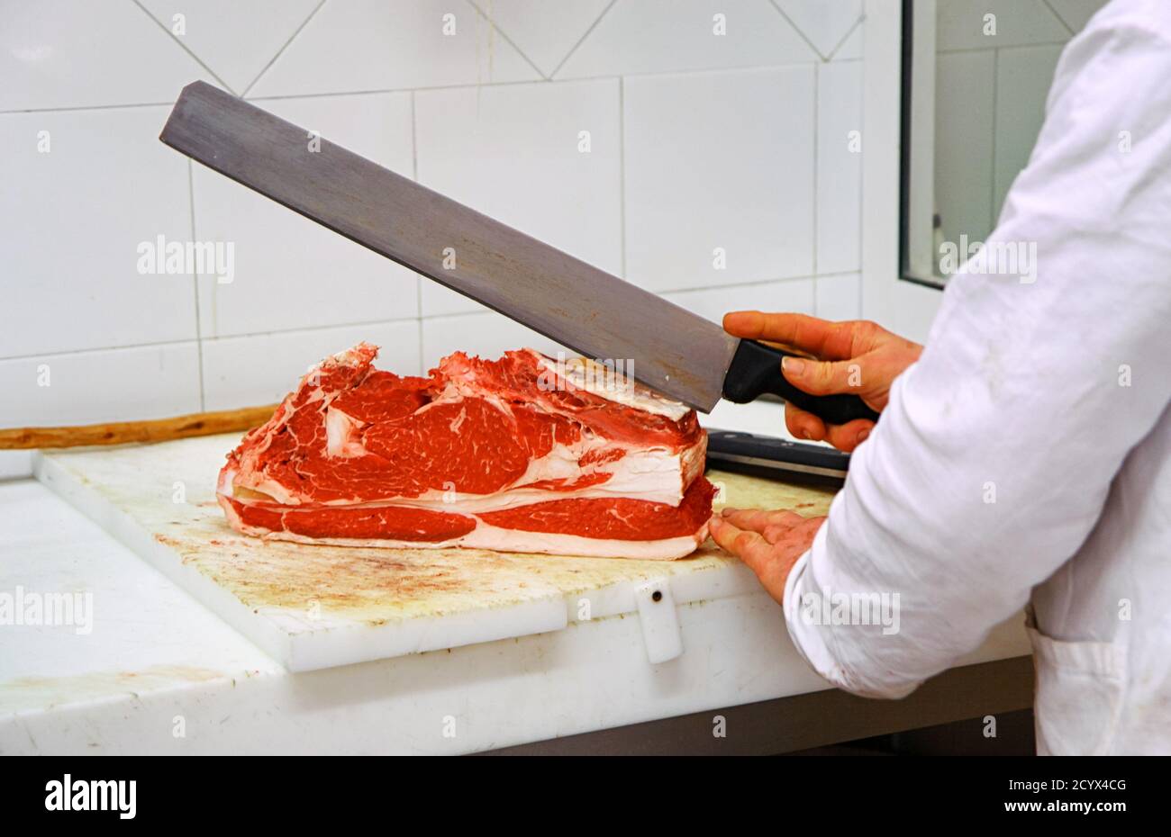 Man chopping meat at meat market hi-res stock photography and images ...