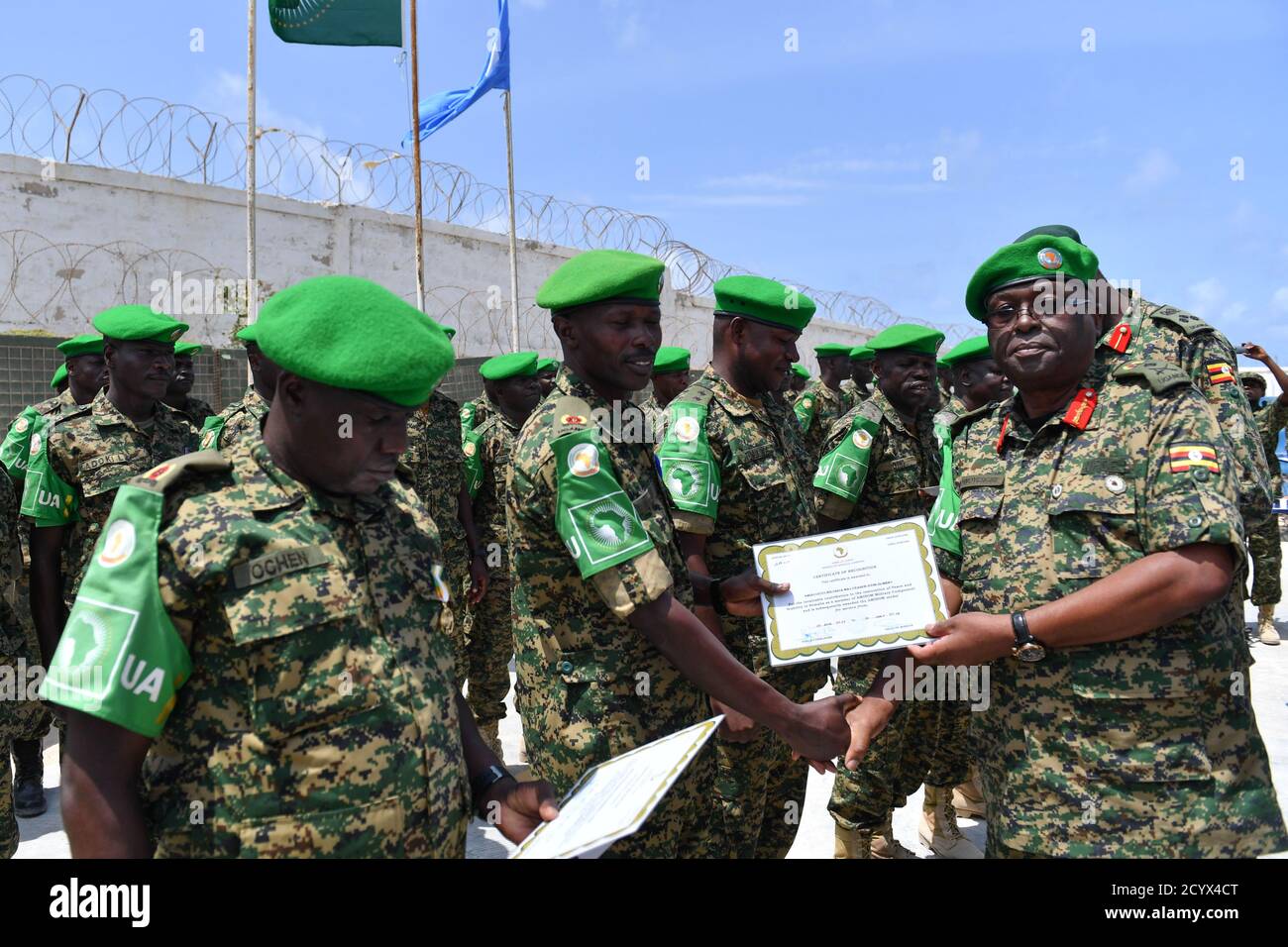 Lt. Gen. Jim Besigye Owoyesigire, the AMISOM Force Commander, hands ...