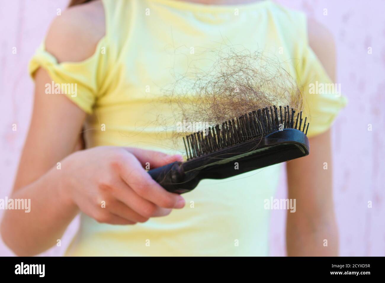Girl is shocked by amount of hair that has fallen out Stock Photo - Alamy