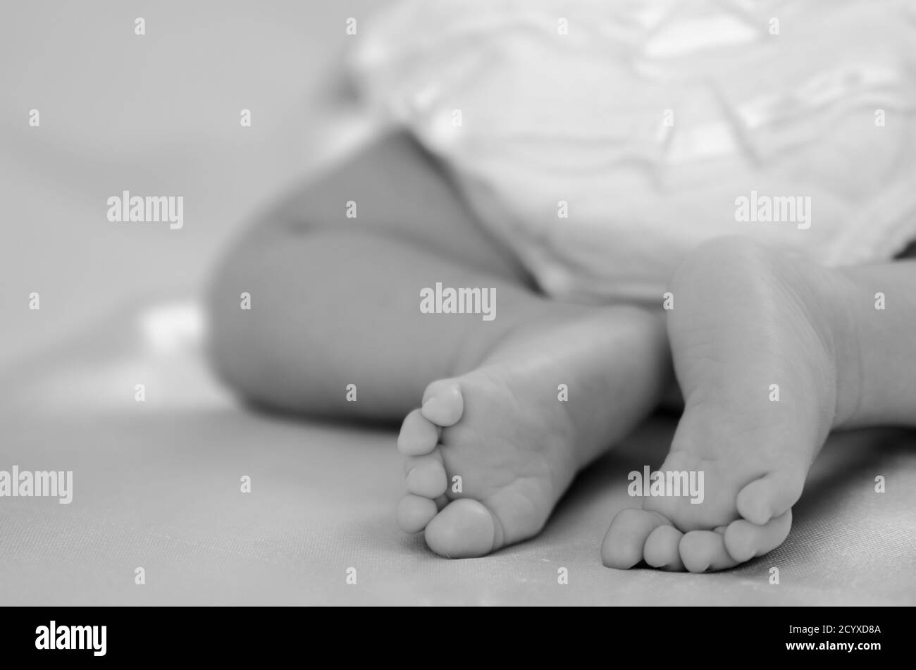 Grayscale shot of legs of a newborn Stock Photo - Alamy