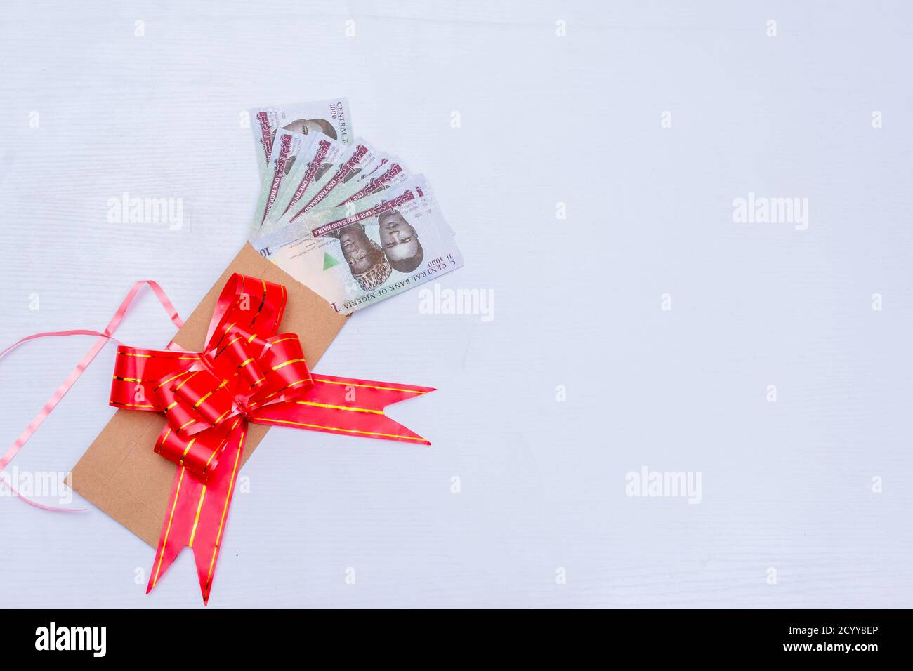 money in an envelope wrapped with a ribbon on a white background Stock ...