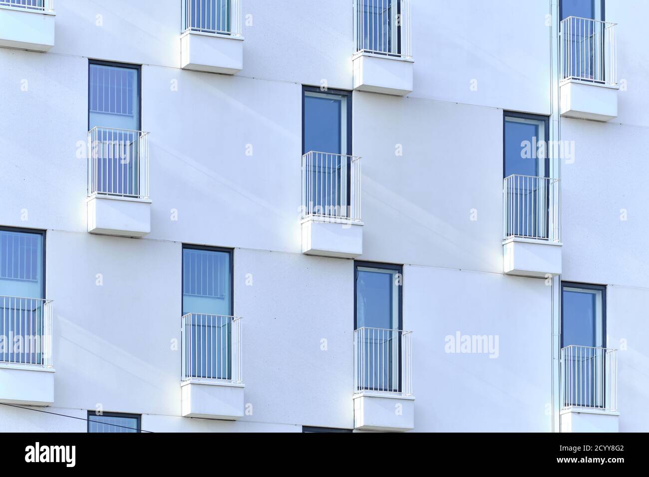 The French balconies on the modern white facade of the apartment ...