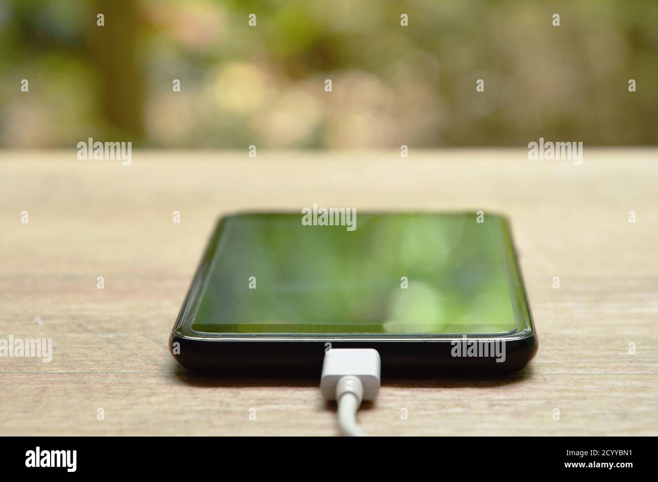 mobile phone stabbing in rechargeable battery with white rubble cable ...